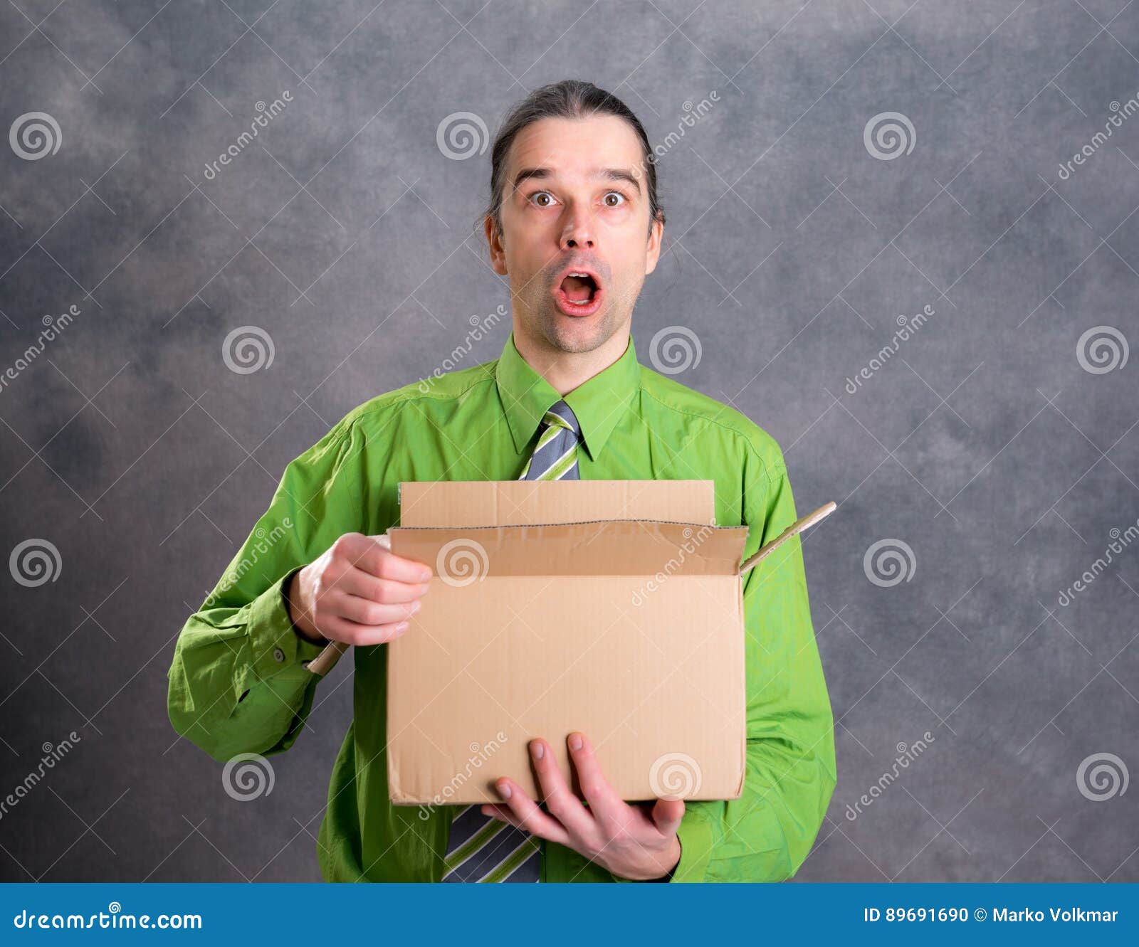 Man Opening a Package and Looking Surprised Stock Photo - Image of ...