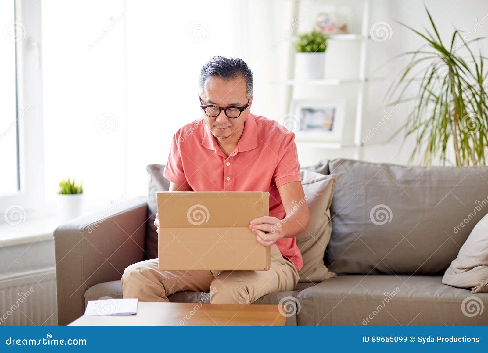 Man Opening Parcel Box at Home Stock Image - Image of gift, glasses ...