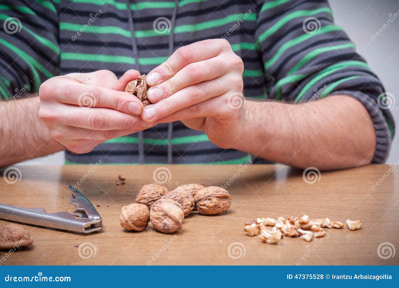 Man Opening Some Walnuts on a Table Stock Photo - Image of vintage ...