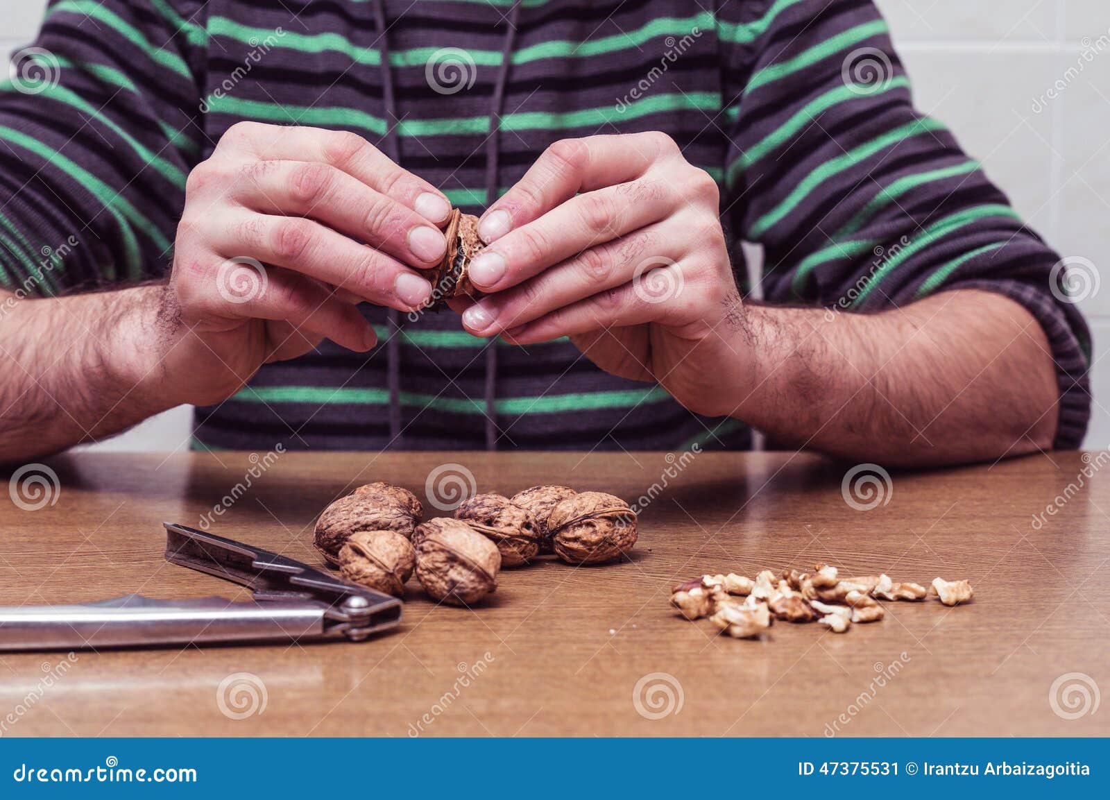 Man Opening Some Walnuts on a Table Stock Image - Image of shell ...