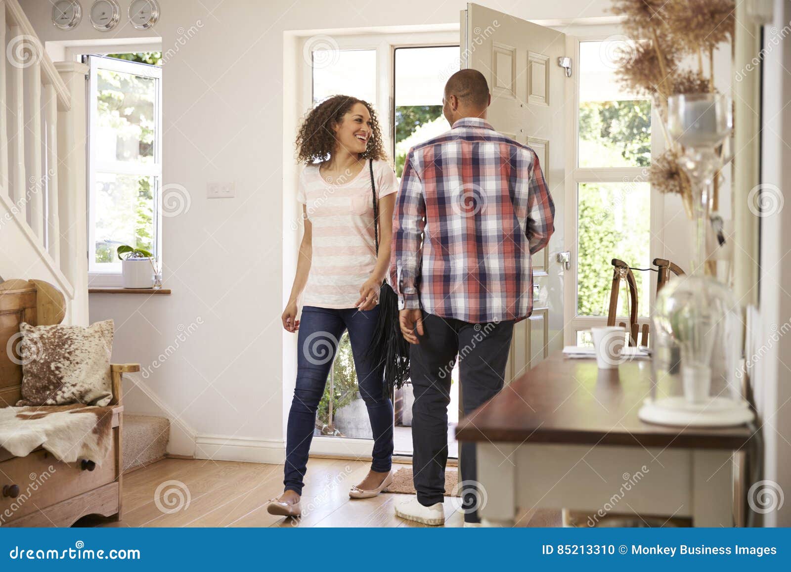 Man Opens Front Door for Woman Returning Home from Work Stock Photo ...