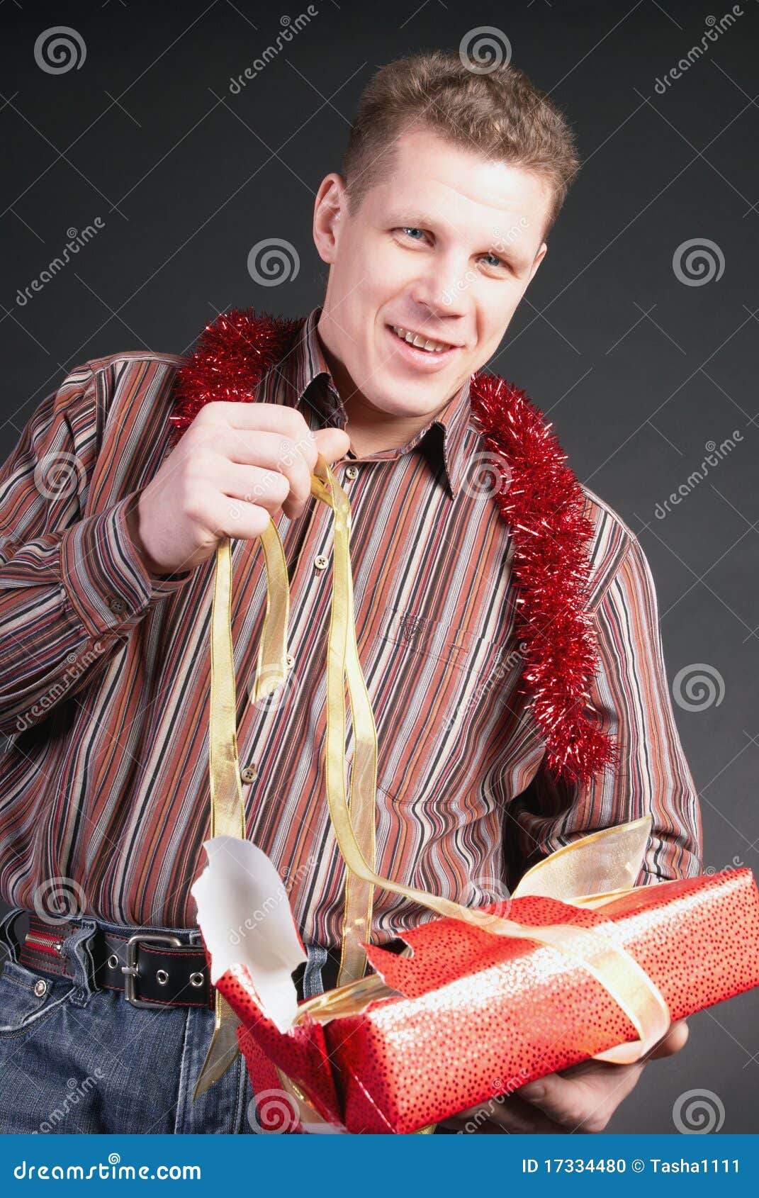 A man opens a gift stock photo. Image of packaging, happy - 17334480