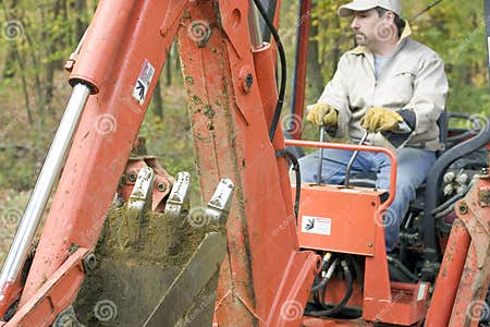 Man Operating Backhoe stock photo. Image of construction - 3411080