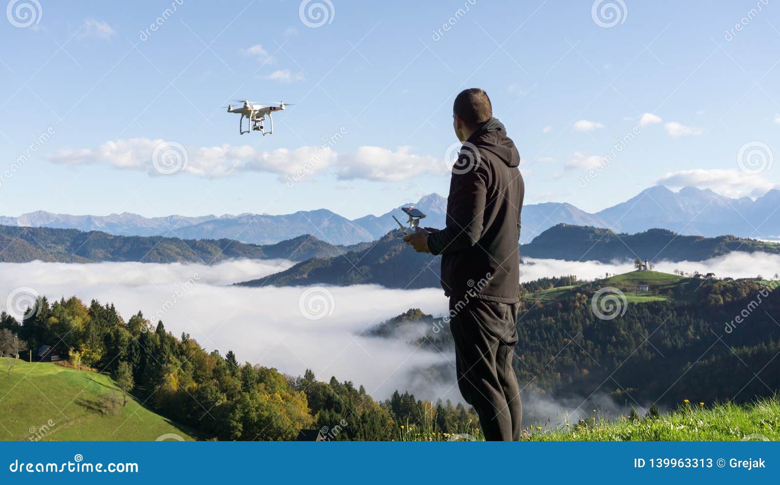Man Operating Drone Flying or Hovering by Remote Control with Beautiful ...