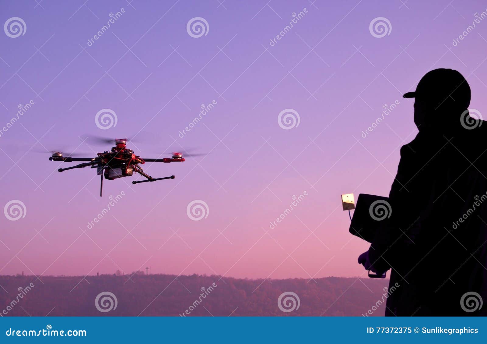 Man Operating a Drone with Remote Control. Dark Silhouette Again Stock ...