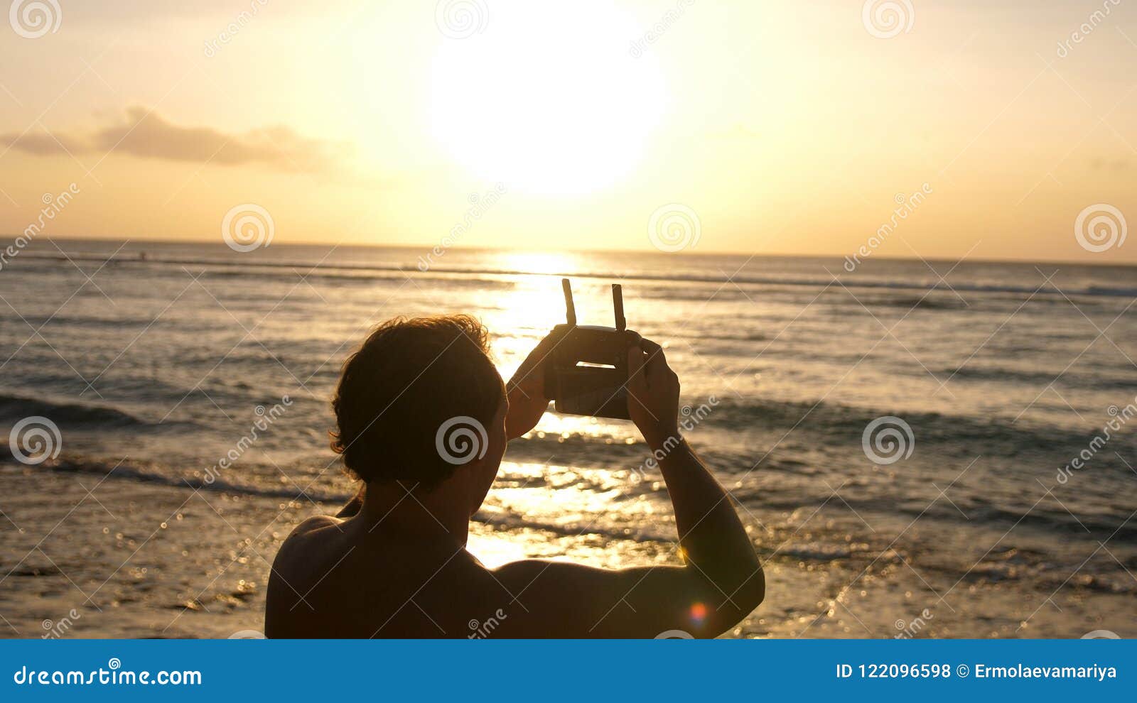 Man Operating a Drone with Remote Control. Quadro Copter Drone Flying ...