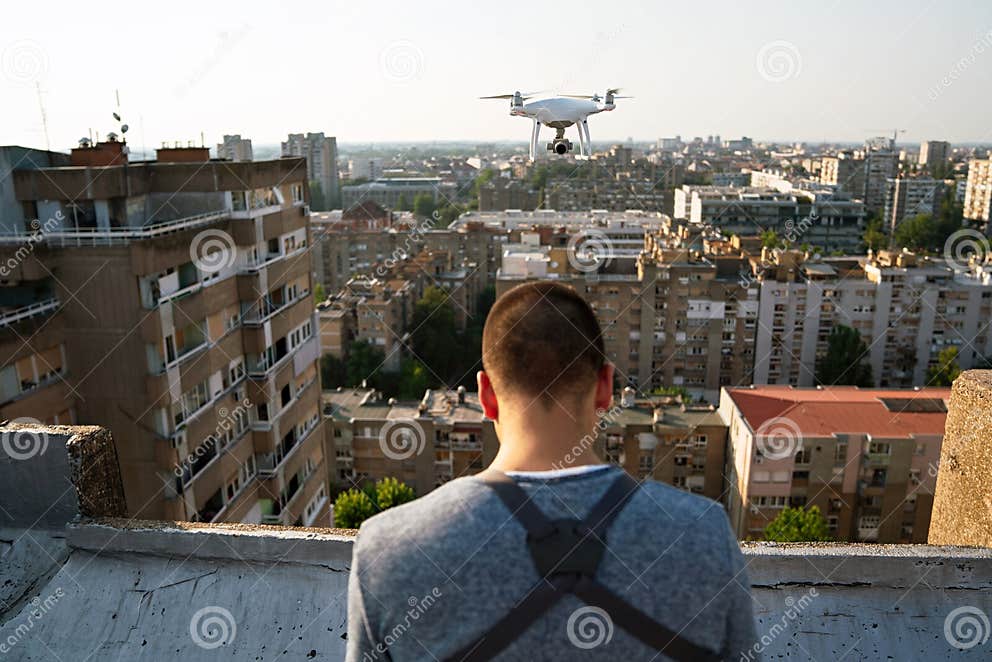 Man Operating a Drone with Remote Control on Rooftop Stock Image ...