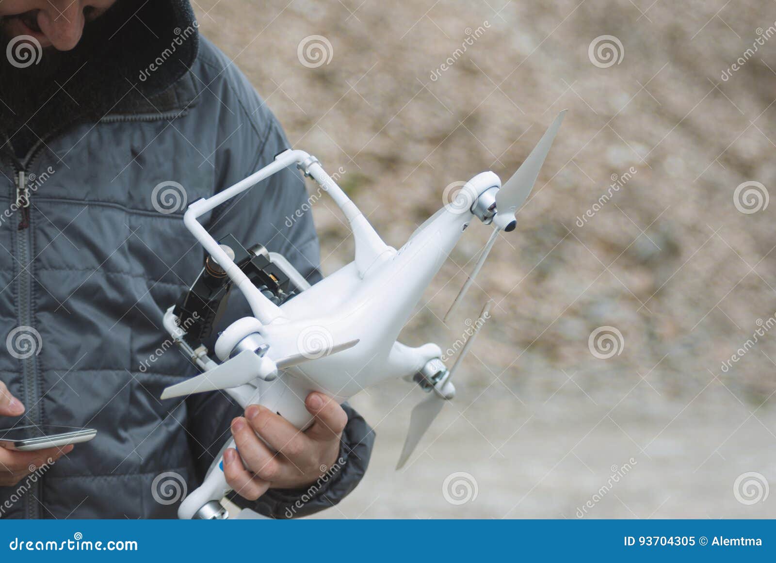 Man Operating Flying Drone with Remote Controller and Smart Phone Stock ...