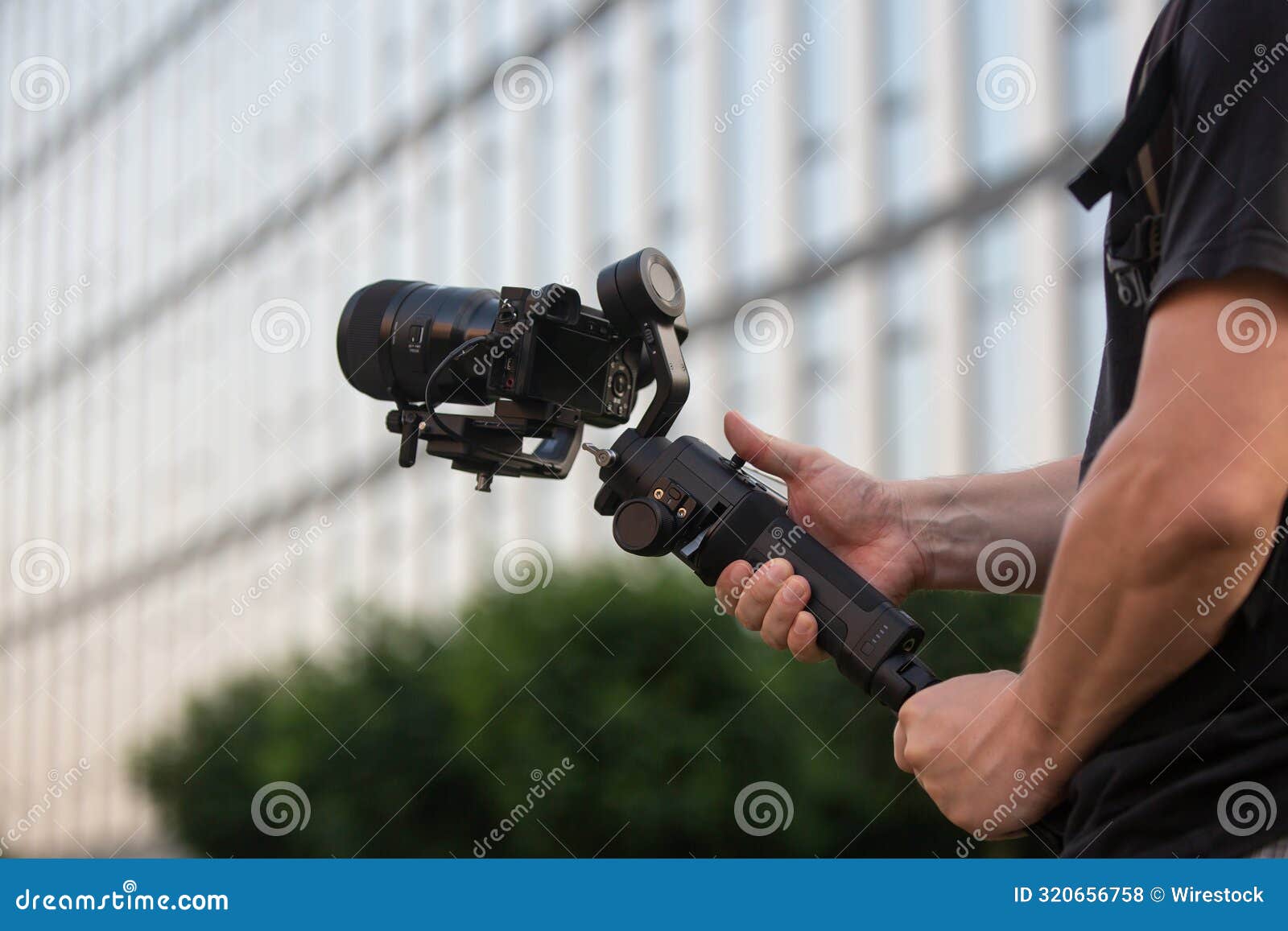 A Man Operating Camera Mounted on a Gimbal, Focus on the Gimbal and ...