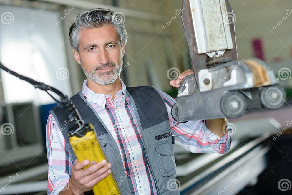 Man operating machine stock image. Image of manufacture - 328786631