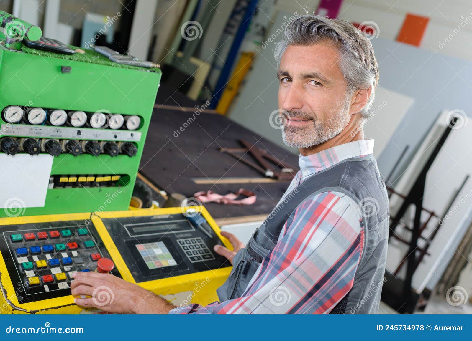 Man operating machinery stock photo. Image of operation - 245734978