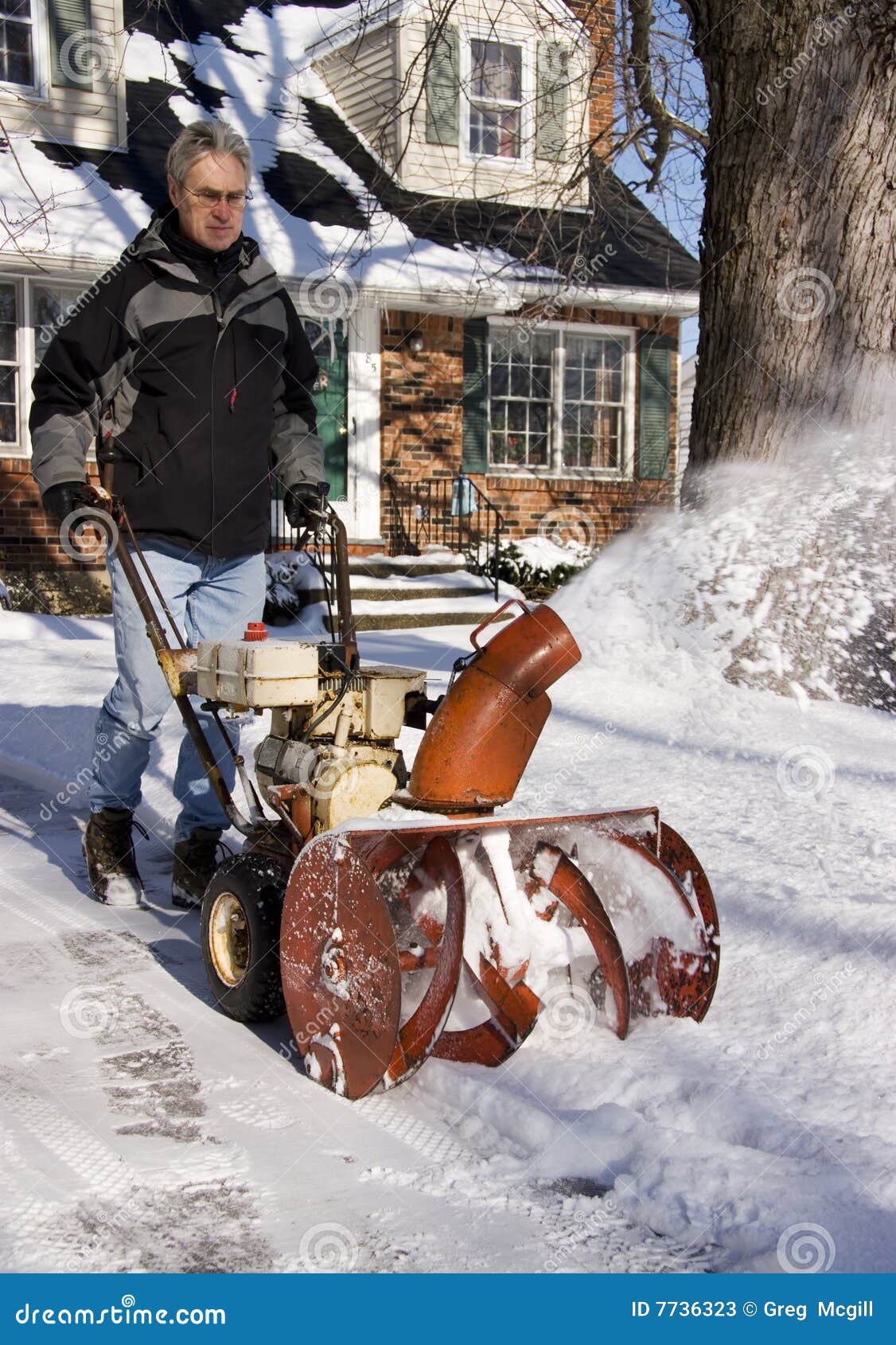 Man Operating Snow Blower To Remove Snow On Driveway. Man Using A ...