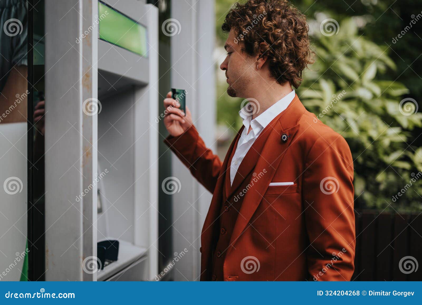 Man in Orange Suit Experiencing ATM Withdrawal Problem Outdoors Stock ...