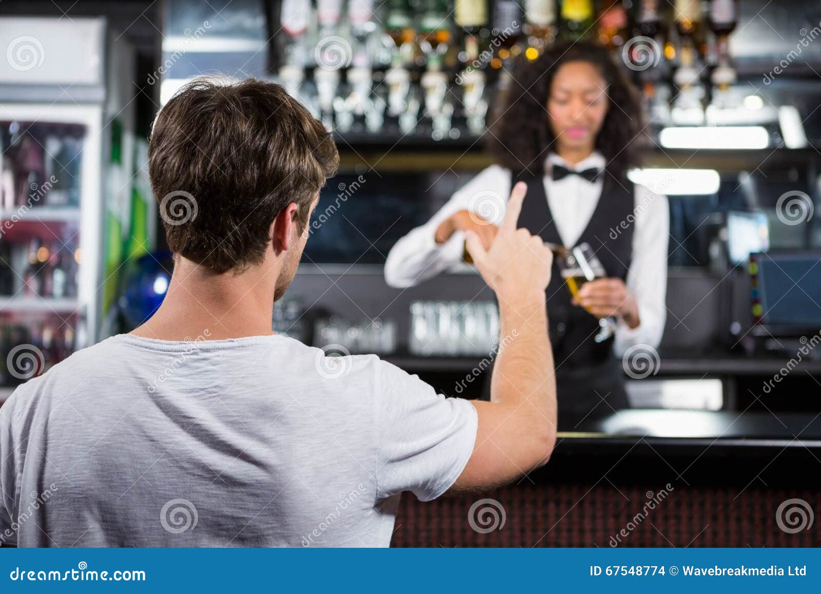 Man Ordering a Drink at Bar Counter Stock Photo - Image of female, head ...