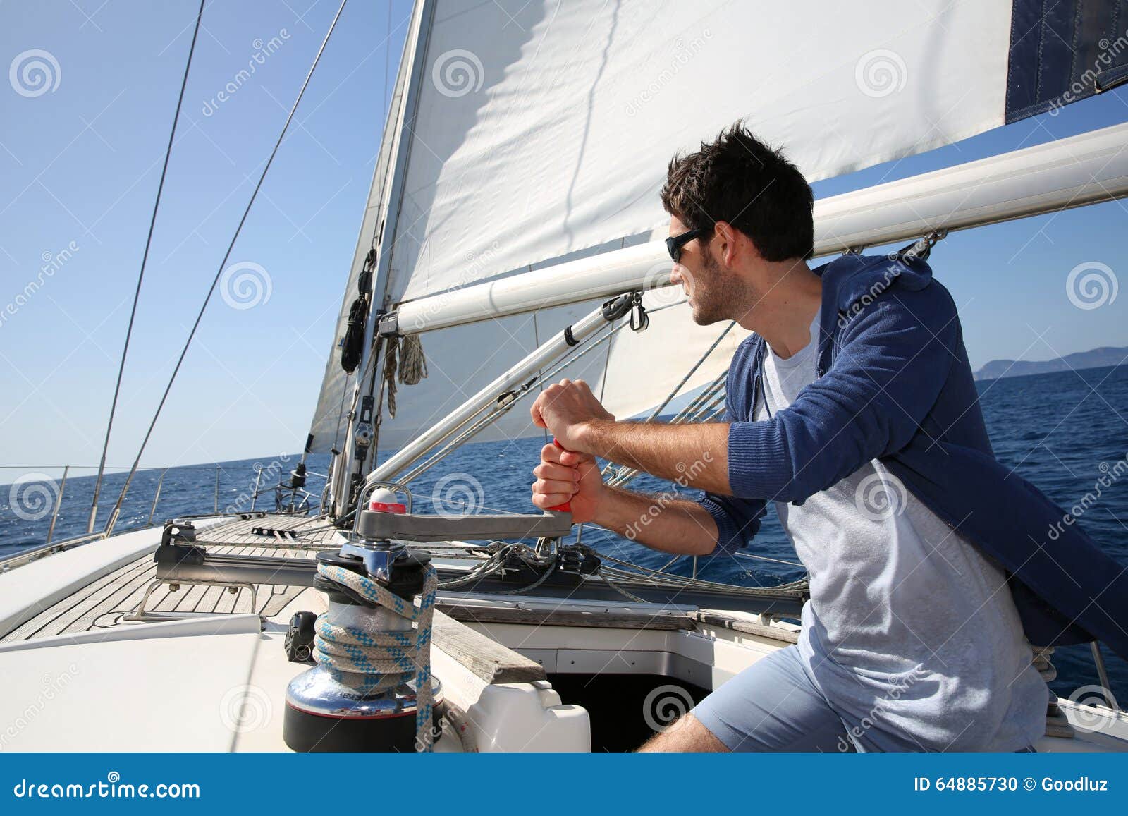 Man Orienting the Sails on a Boat Stock Photo - Image of ocean ...