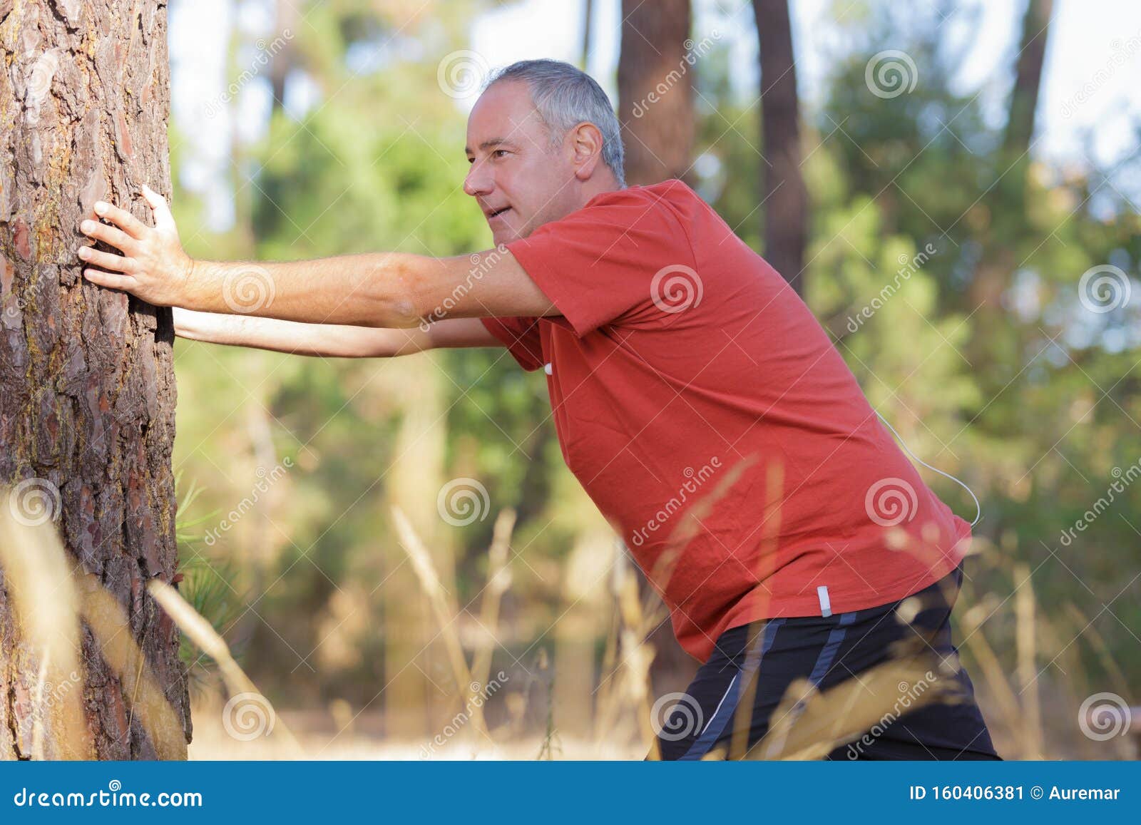 Man Out Exercising Stretching Against Tree Stock Image - Image of ...