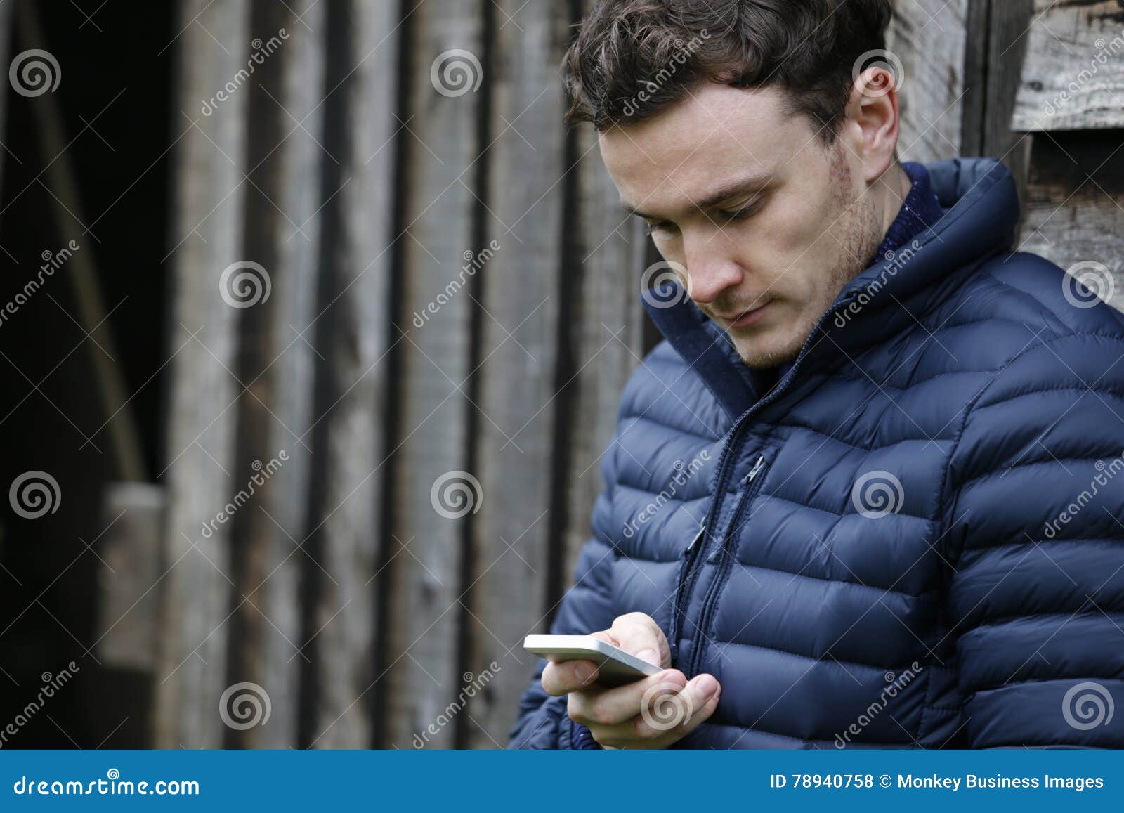 Man Outdoors Checking Mobile Phone Stock Photo - Image of padded ...