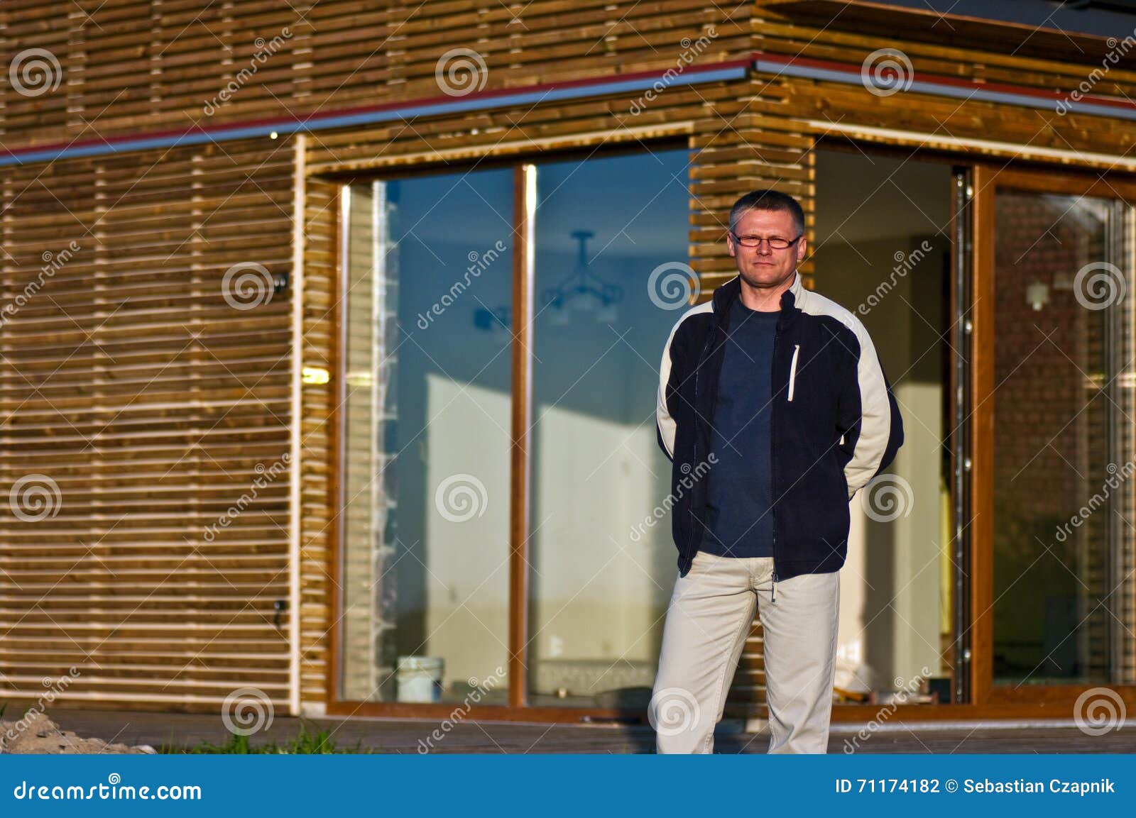 Man outside new eco home stock photo. Image of cottage - 71174182