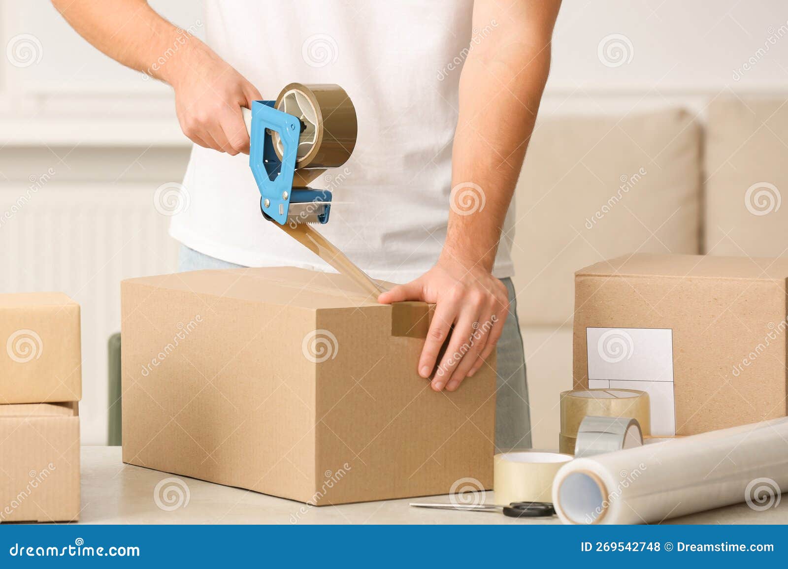 Man Packing Box with Adhesive Tape Indoors, Closeup Stock Photo - Image ...