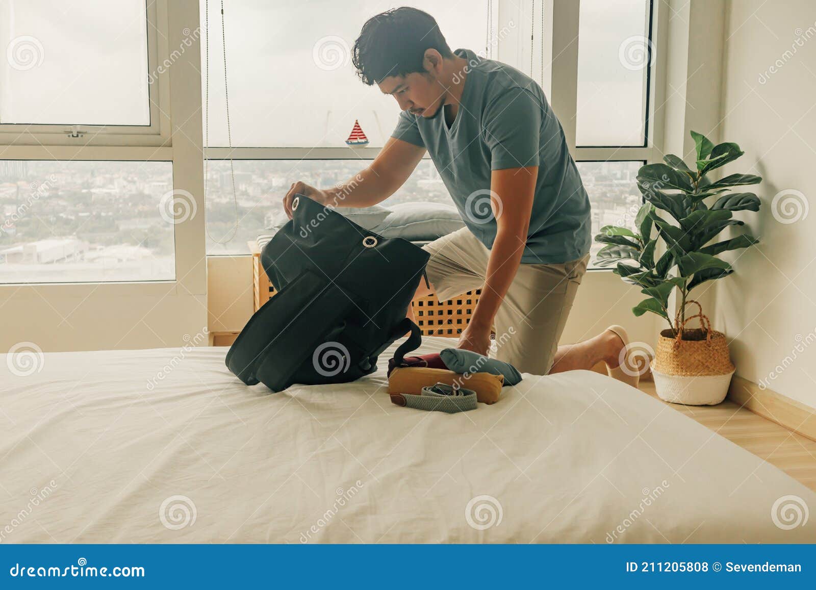 Man is Packing His Backpack Ready for Traveling. Stock Photo - Image of ...