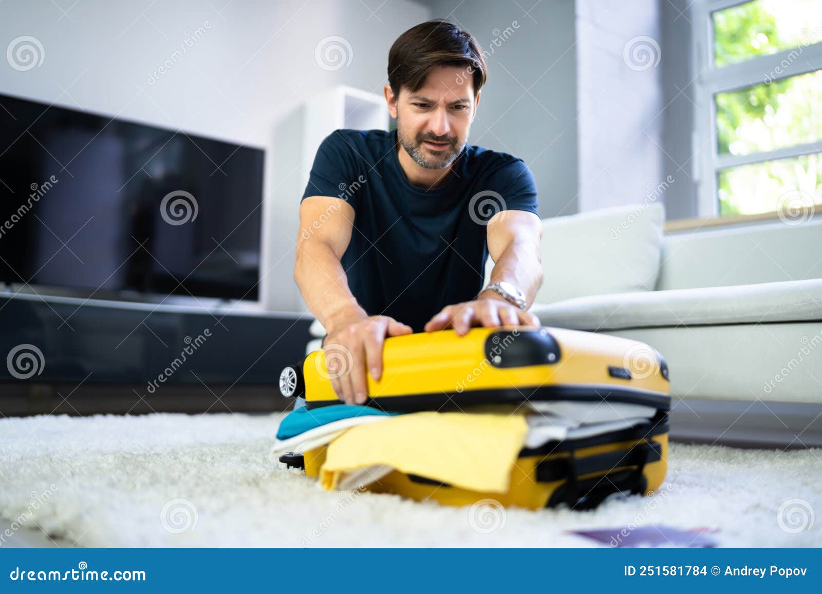 Man Packing Stuffed Suitcase Bag Stock Photo - Image of apartment ...