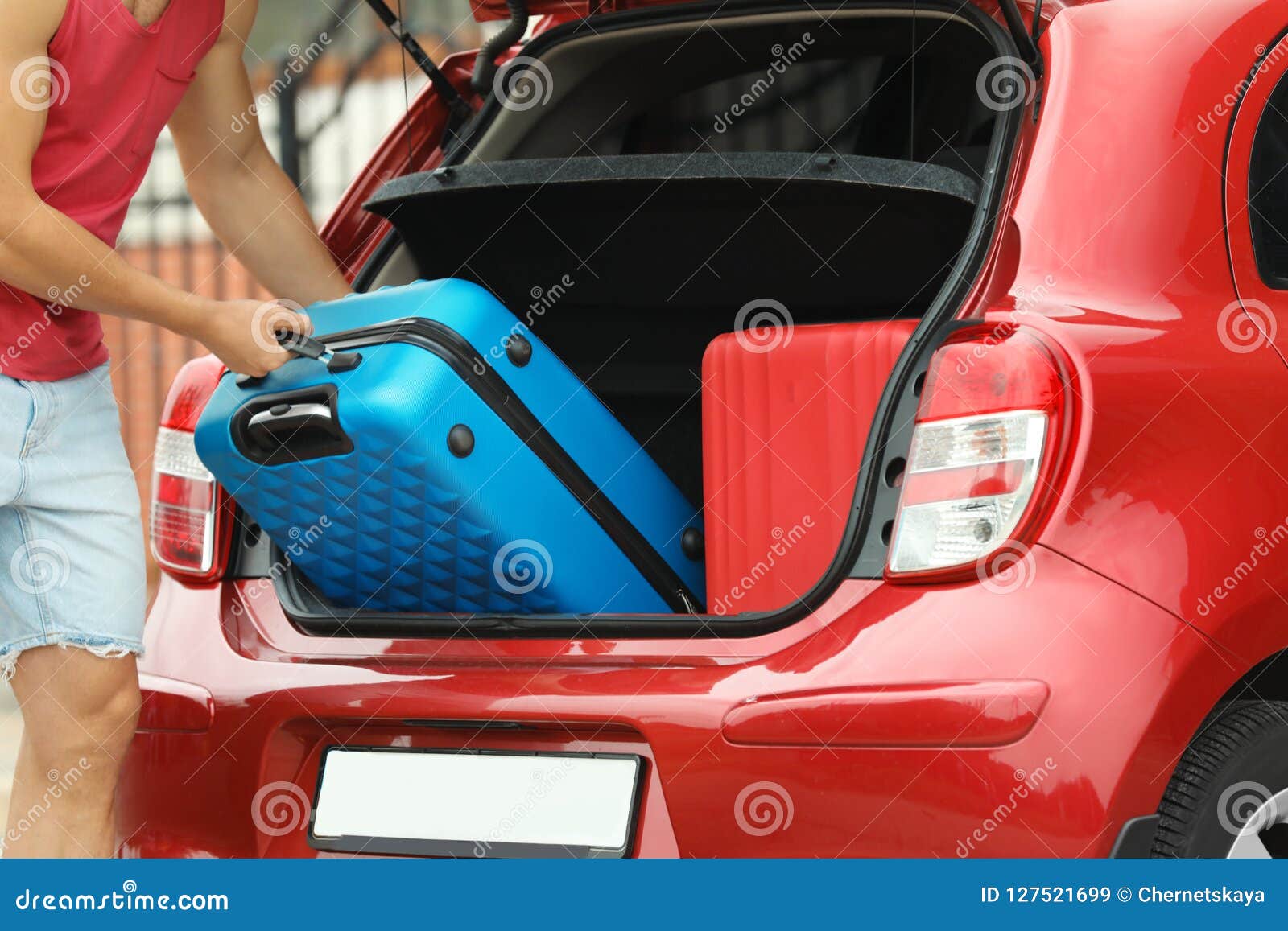 Man Packing Suitcase into Car Trunk Outdoors Stock Image - Image of ...