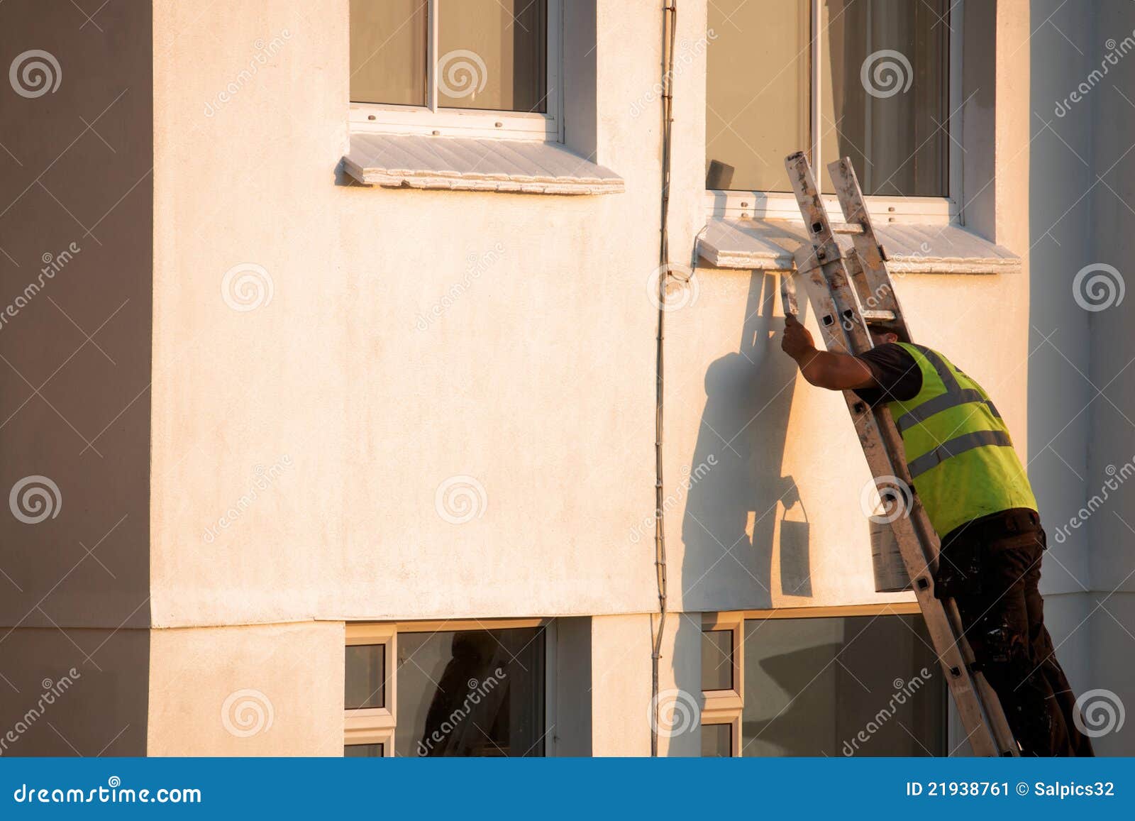 A man painting a building stock image. Image of house - 21938761