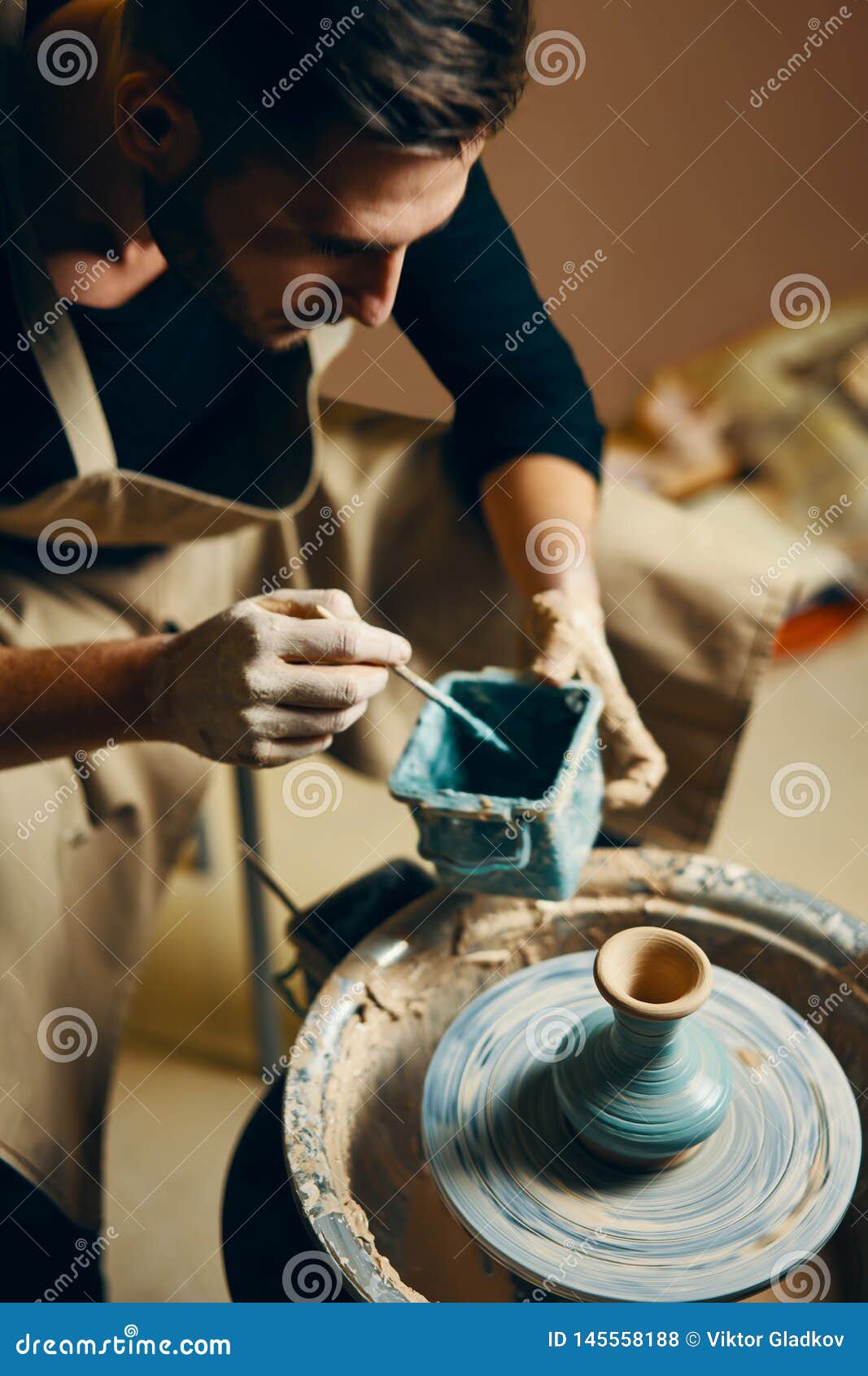 Man Painting Handmade Pottery at Ceramic Workshop Stock Photo - Image ...