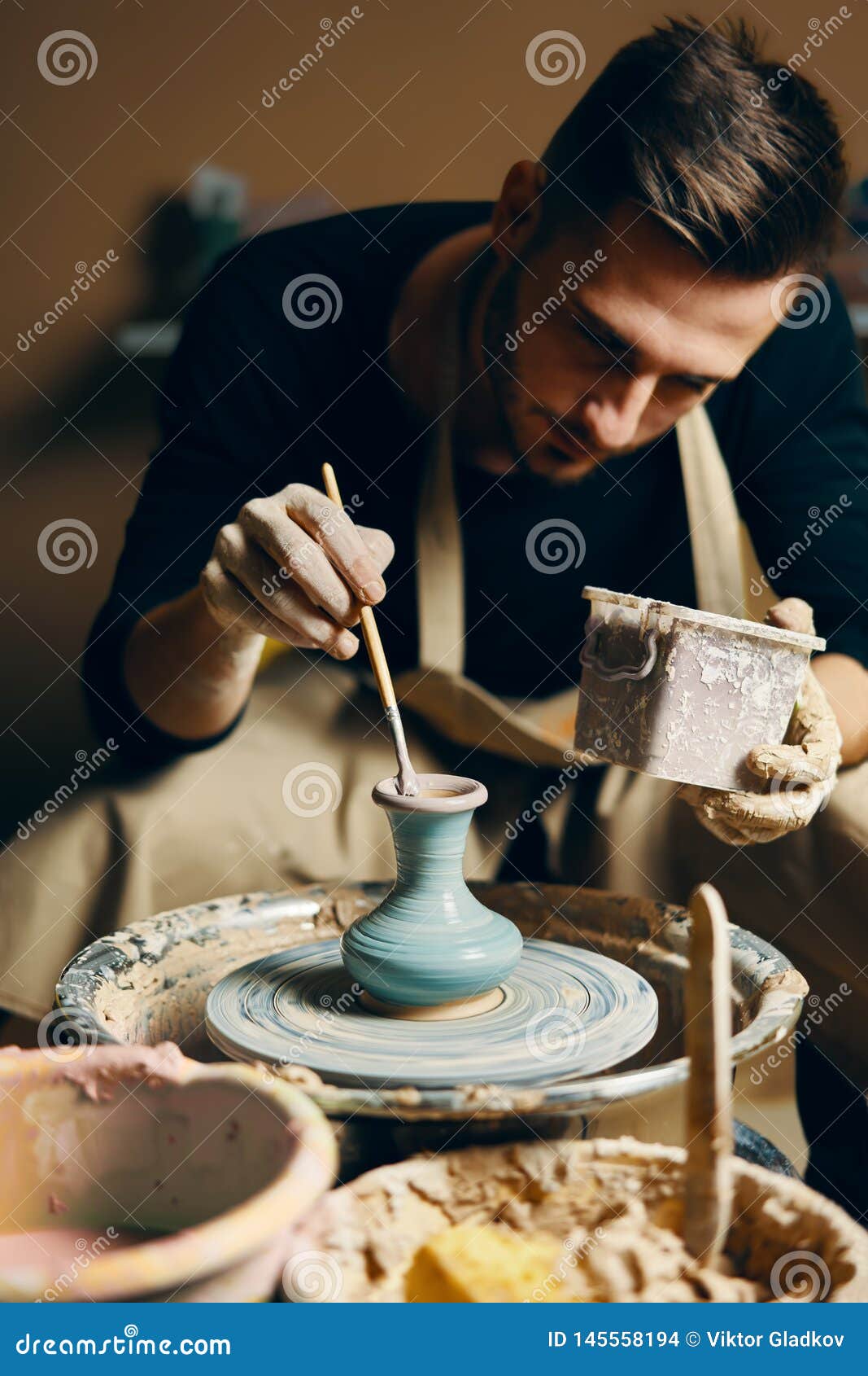 Man Painting Handmade Pottery at Ceramic Workshop Stock Photo - Image ...