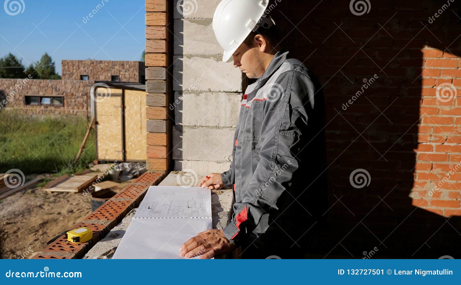 Man with Paper Draft in Building Under Construction Stock Image - Image ...
