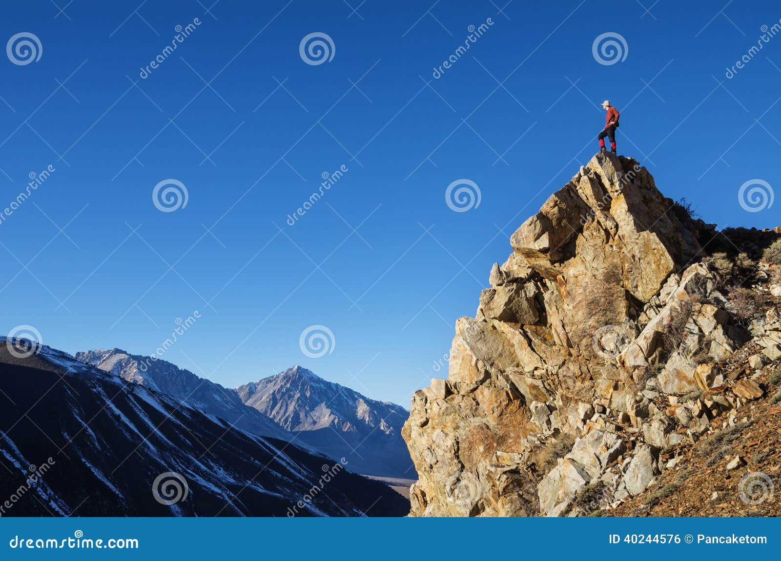 Man on Peak Looking at Mountains Stock Photo - Image of crag, copyspace ...
