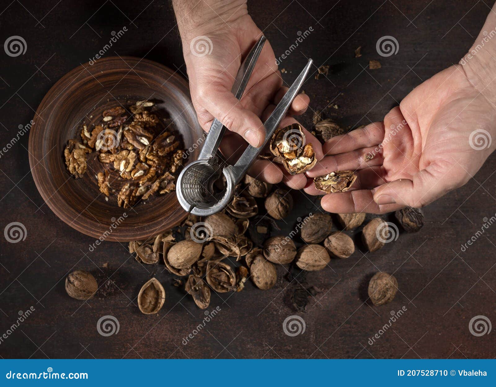 Man peeling nuts stock photo. Image of cracker, ingredient - 207528710
