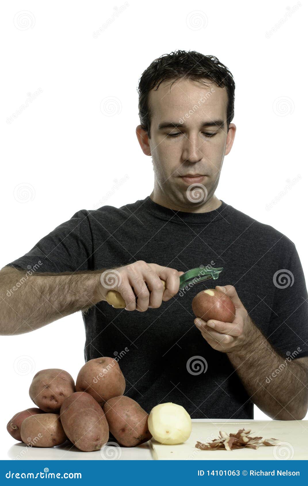 Man Peeling Potatoes Stock Photos - Image: 14101063