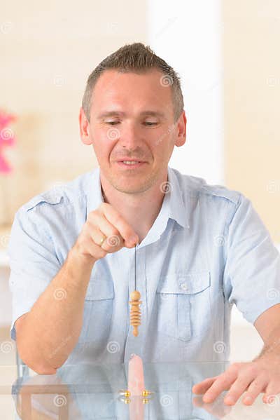 Man with pendulum stock photo. Image of fortunetelling - 41931804