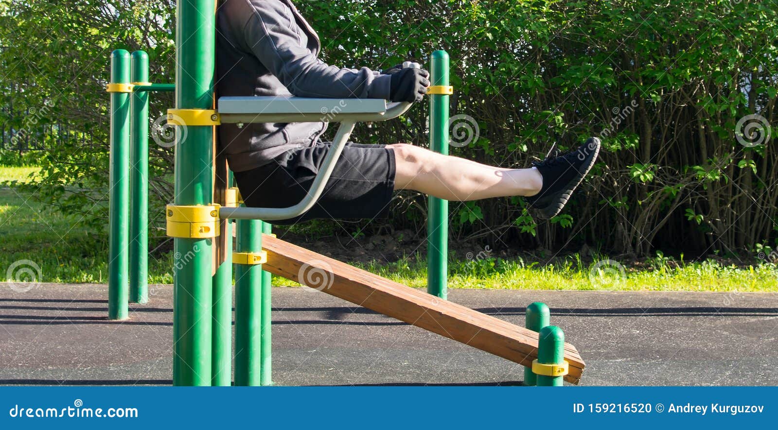 Man Performing an Exercise, on Uneven Bars, Outdoors, Side View Stock ...