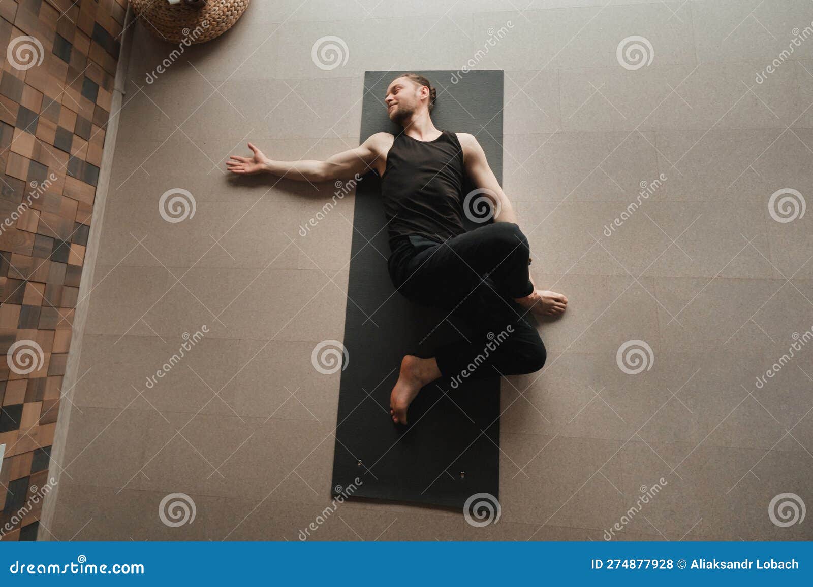 A Man Performing Gymnastic Exercises on a Yoga Mat at Home Stock Photo ...