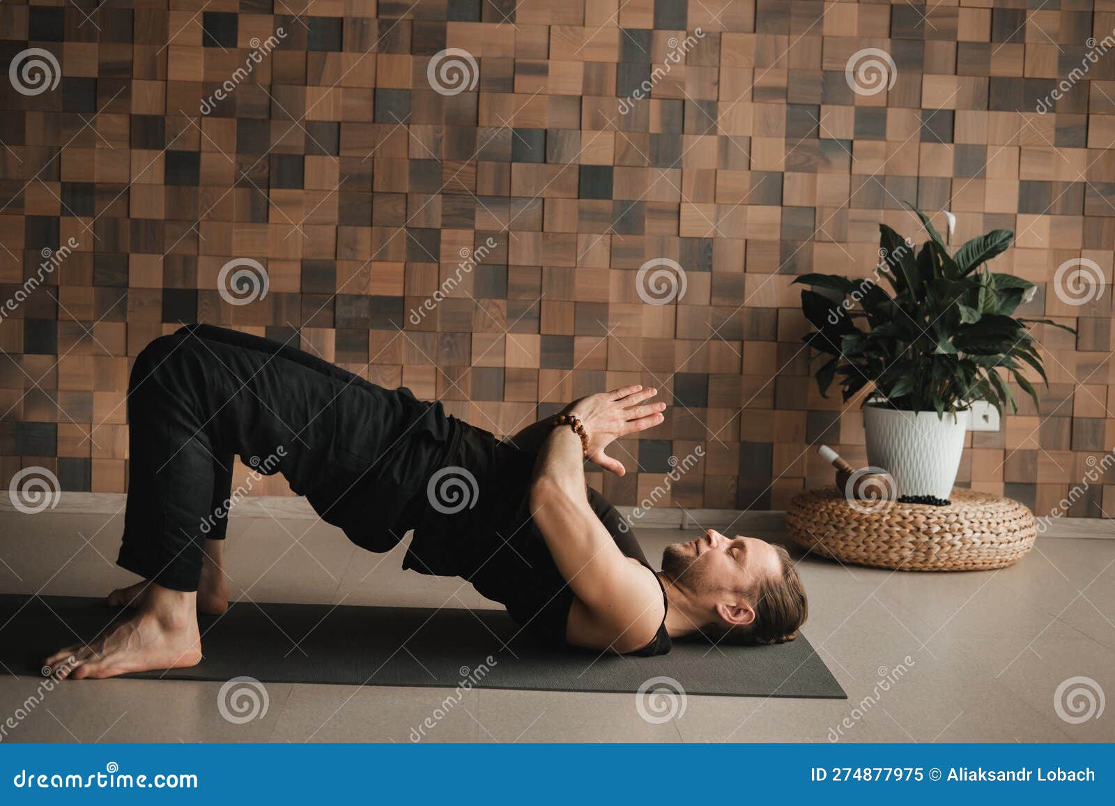A Man Performing Gymnastic Exercises on a Yoga Mat at Home Stock Image ...