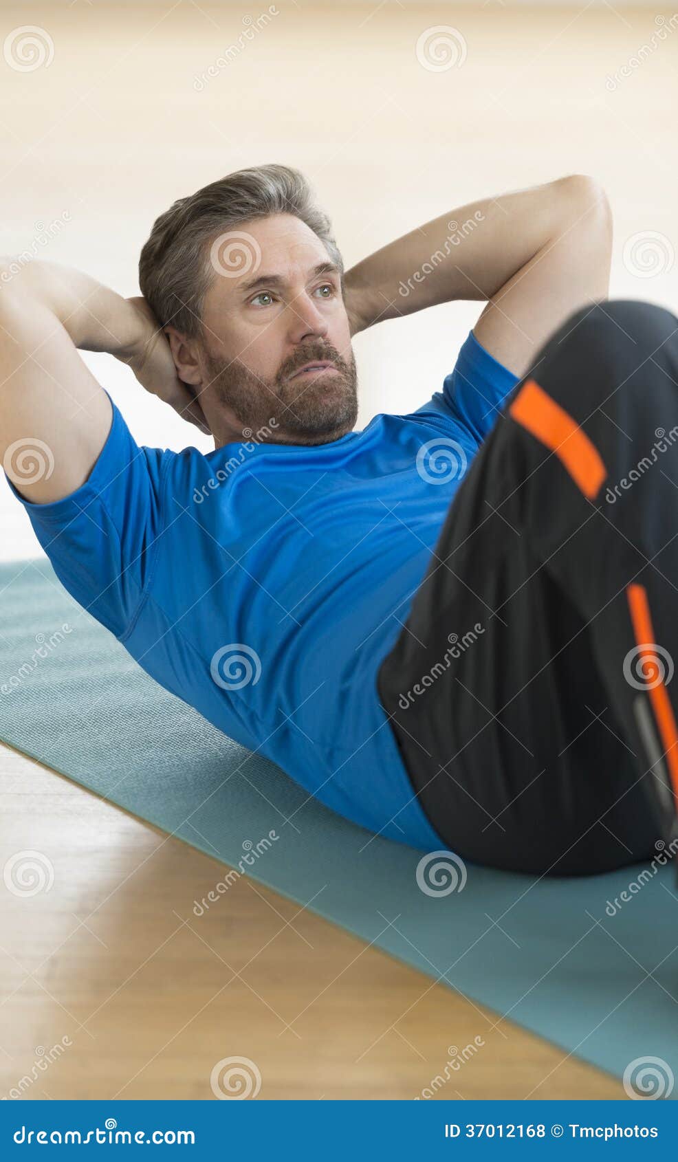 Man Performing Sit-Ups on Exercise Mat Stock Photo - Image of caucasian ...
