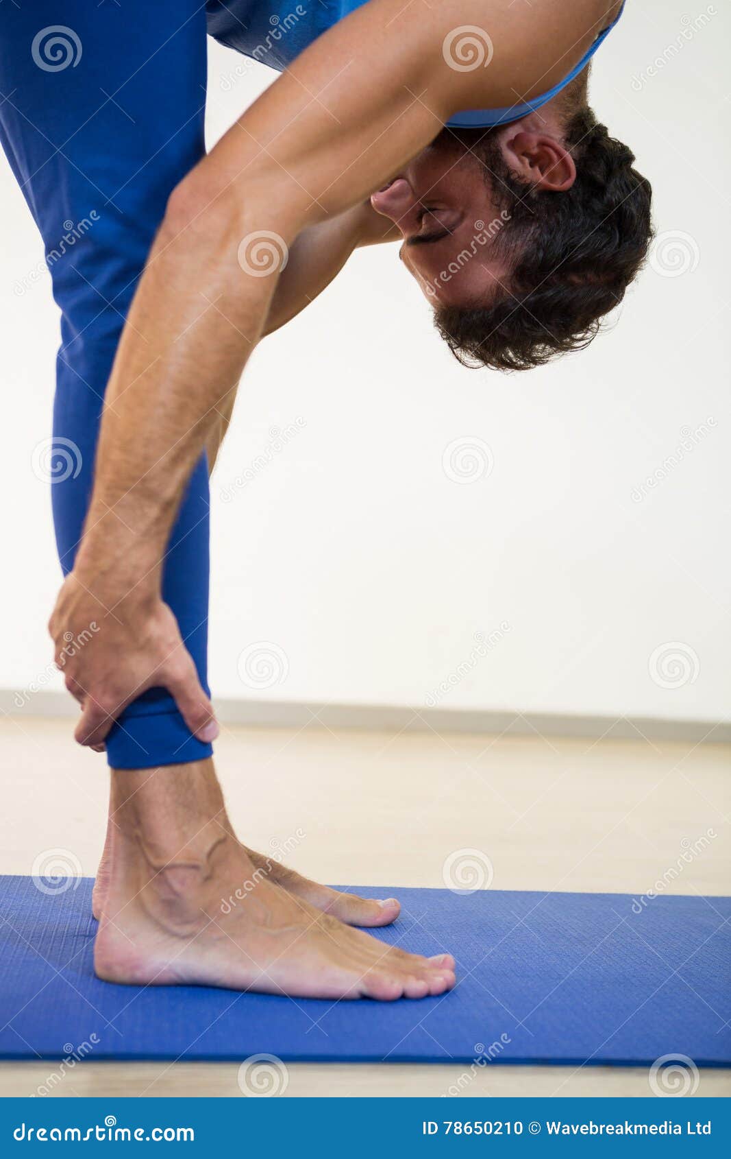 Man Performing Standing Forward Bend Stock Photo - Image of athletic ...