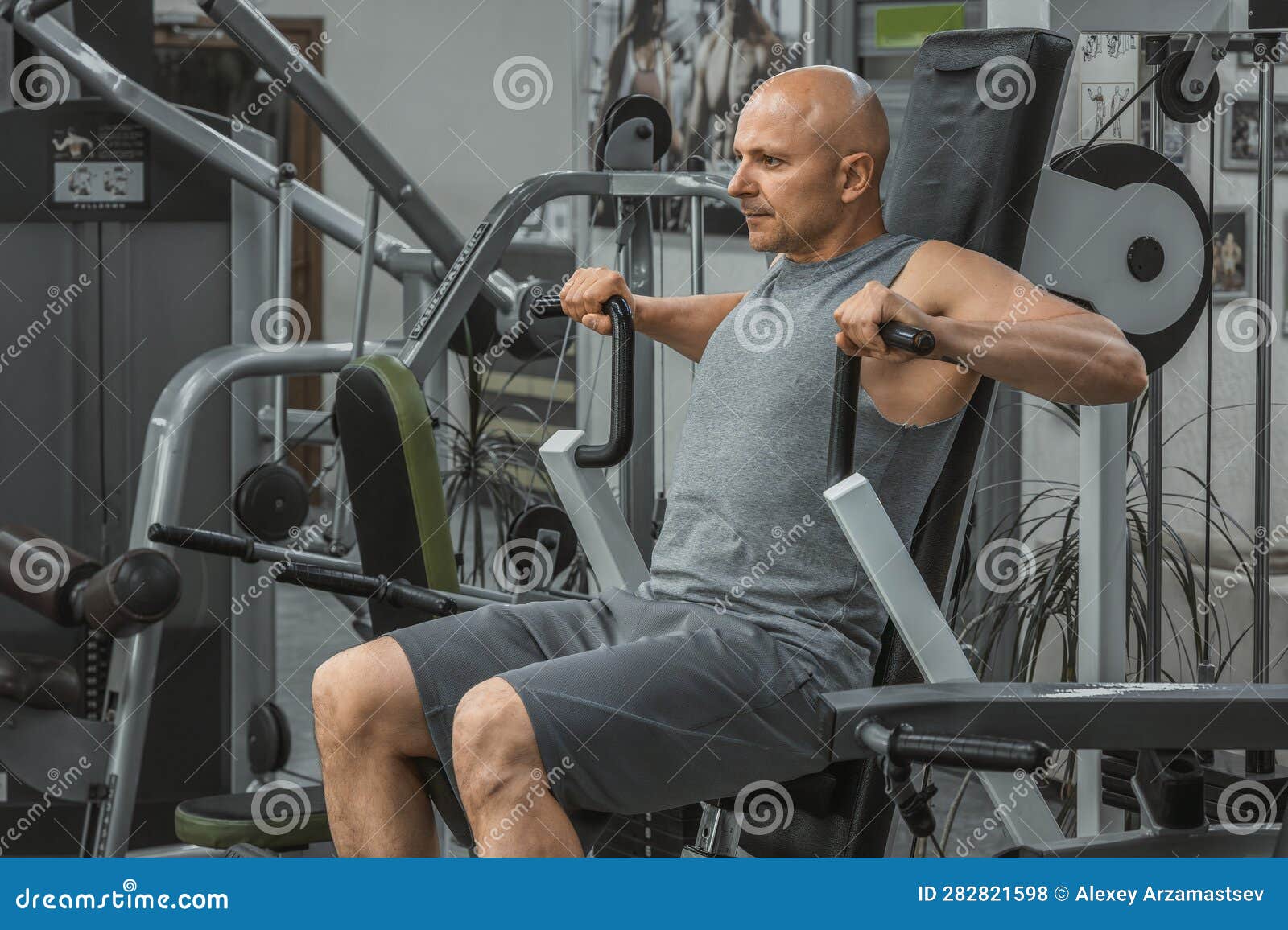 Man Performs an Exercise on a Simulator for Pumping Chest Muscles Stock ...