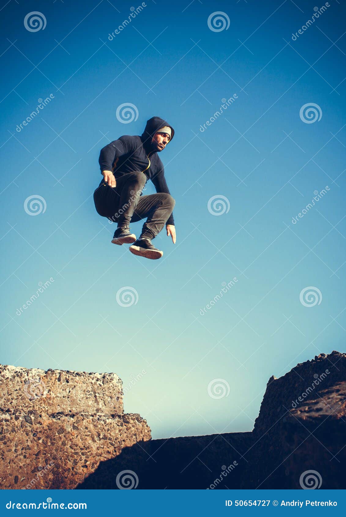 Man Performs Freerunning Jump on Stones Stock Image - Image of freerun ...