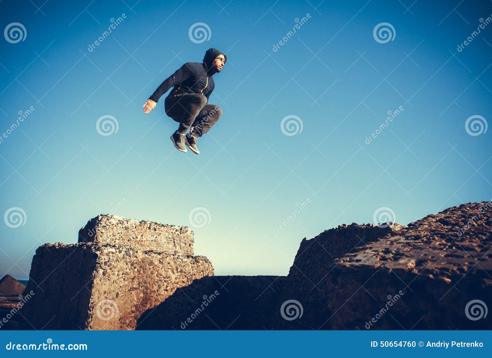 Man Performs Freerunning Jump on Stones Stock Photo - Image of danger ...
