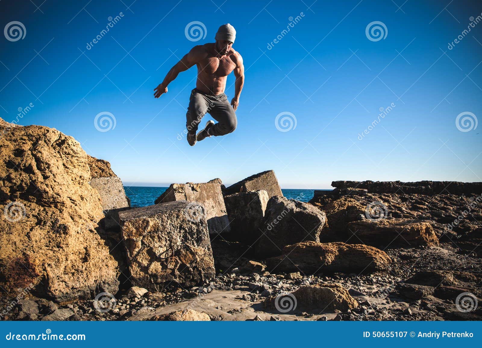 Man Performs Freerunning Jump on Stones Stock Image - Image of rock ...