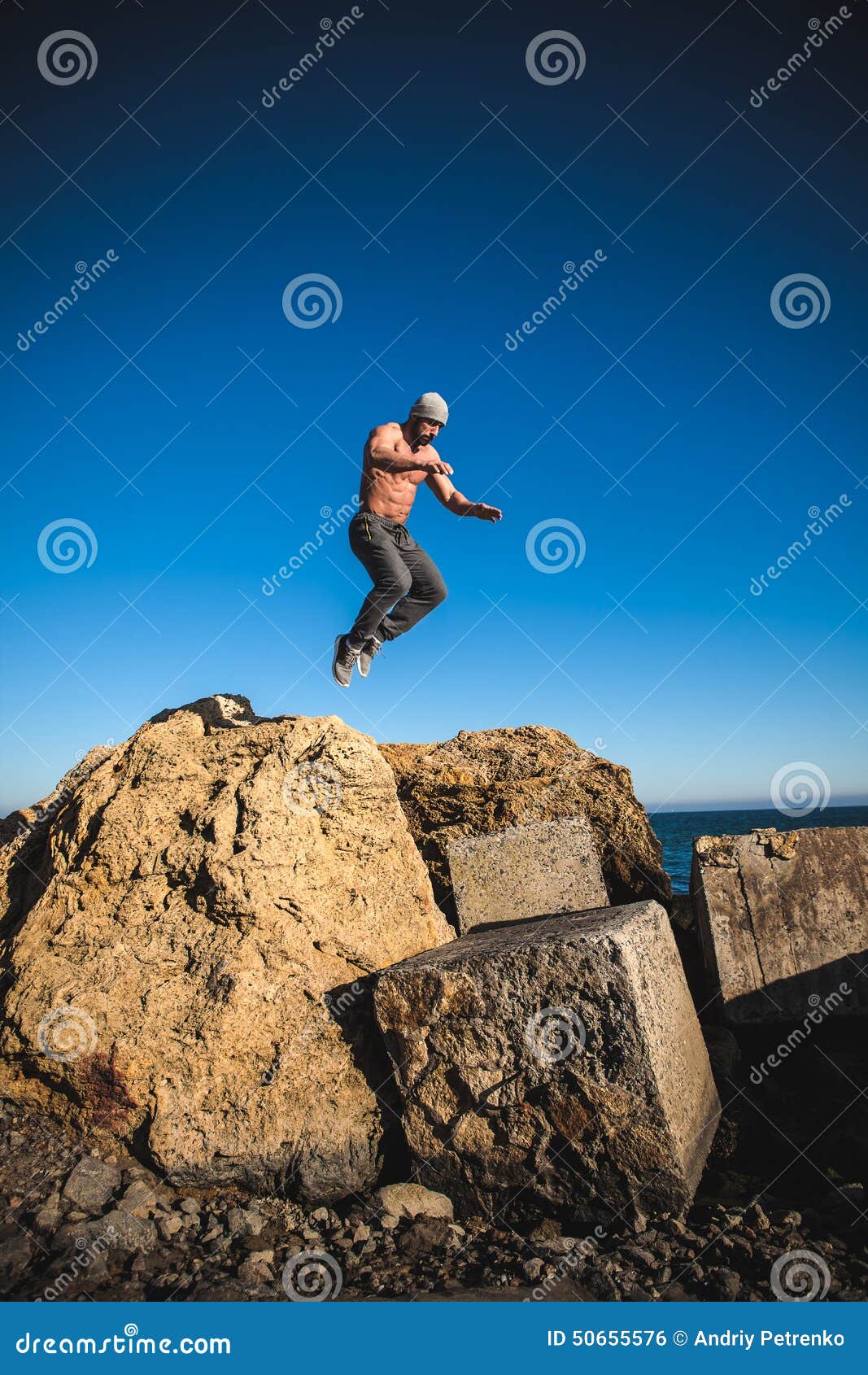 Man Performs Freerunning Jump on Stones Stock Photo - Image of brave ...