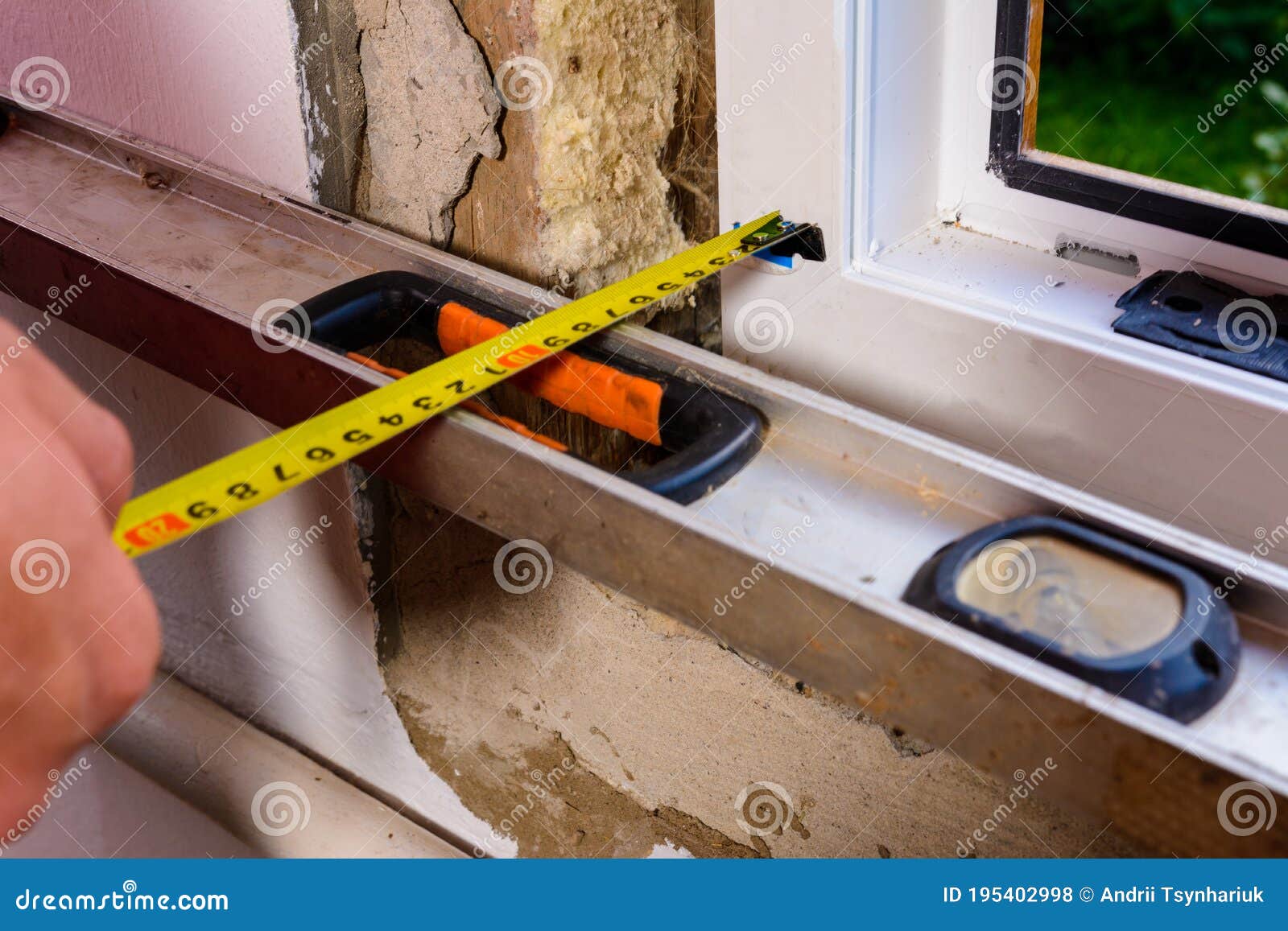 The Man Performs Installation Work with the Window, for this he Also ...