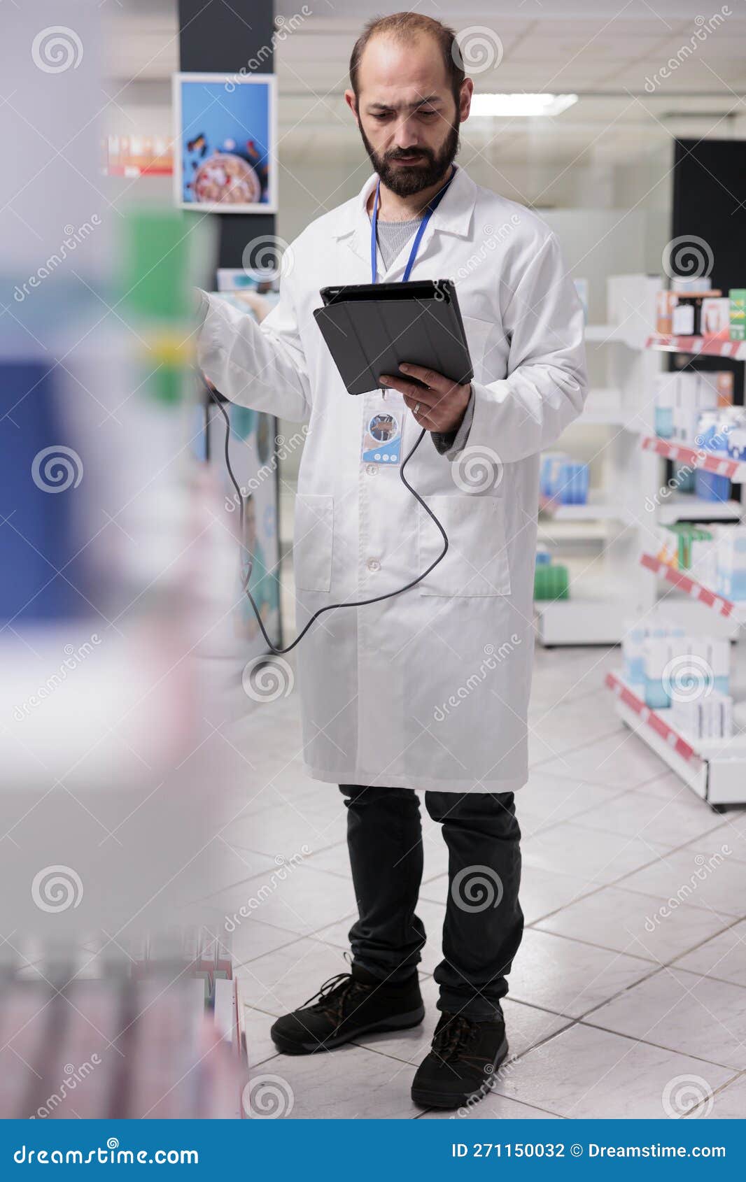 Man Pharmacist Looking at Medical Products Information on Tablet ...
