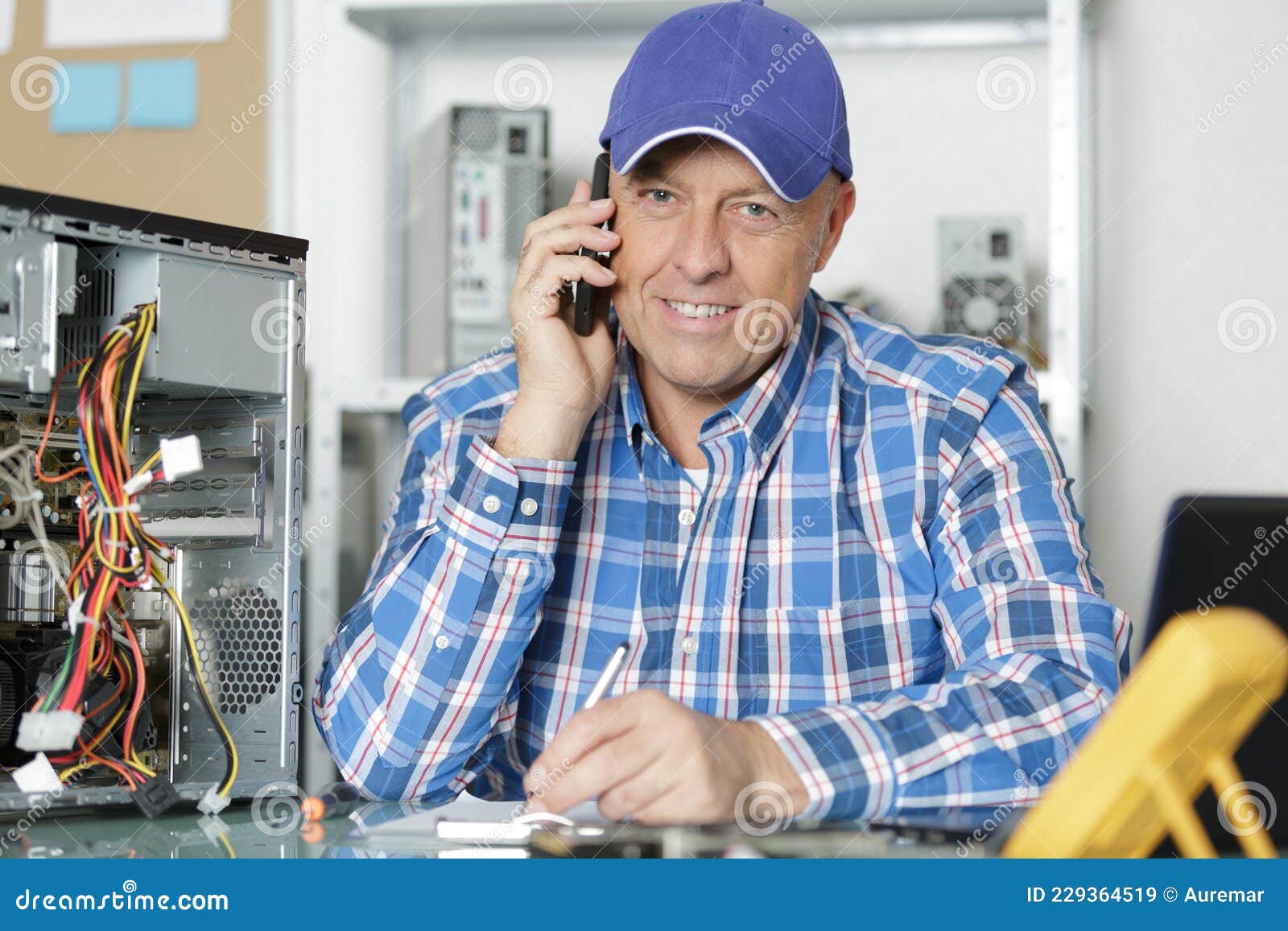 Man on Phone Fixing Computer Stock Image - Image of park, phone: 229364519