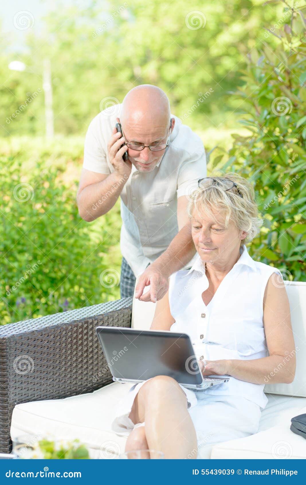 A Man on Phone and His Wife on Computer Stock Image - Image of phone ...