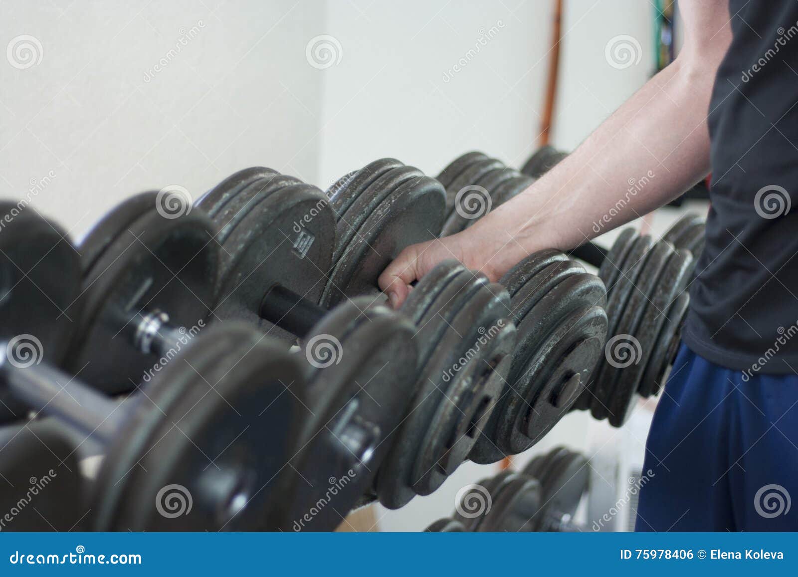 Man Pick Up Dumbbell Weight from Rack in Gym Stock Photo - Image of ...