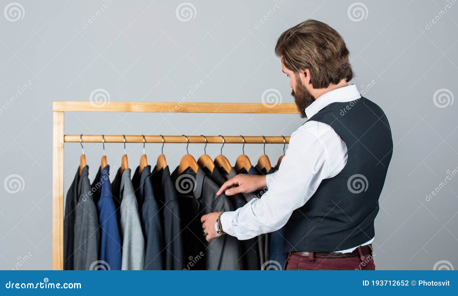 Man Picking Suit from Personal Wardrobe, Tailored Clothes Concept Stock ...